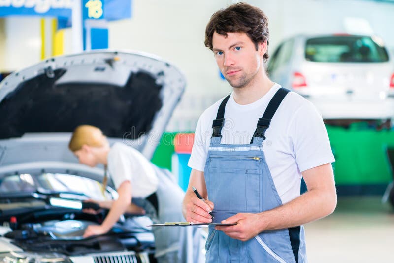 Mechanic Team Working in Car Workshop Stock Image - Image of team ...