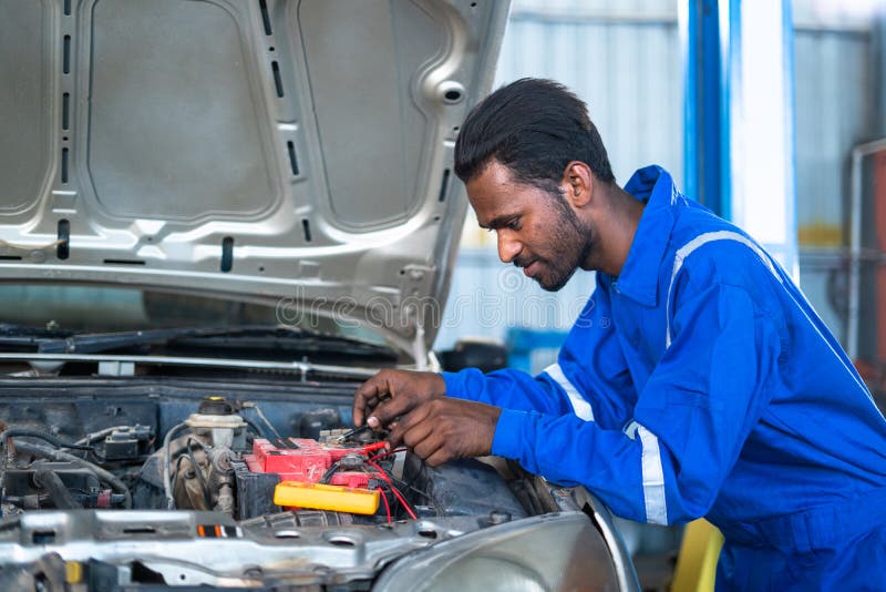 Car Mechanic Testing or Checking Car Engine Battery by Using Digital ...
