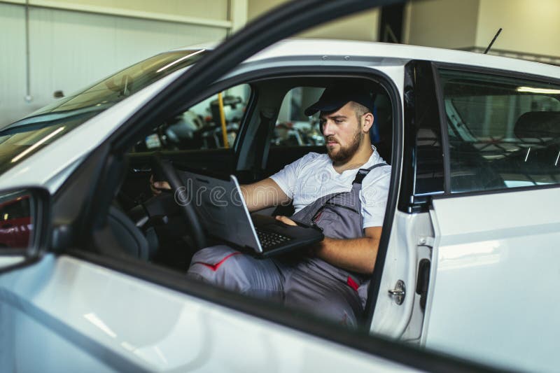 Car Mechanic Working in Auto Repair Service Using Laptop Stock Image ...