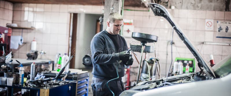 Car Mechanic Working in Auto Vulcanizing and Vehicle Service Workshop ...