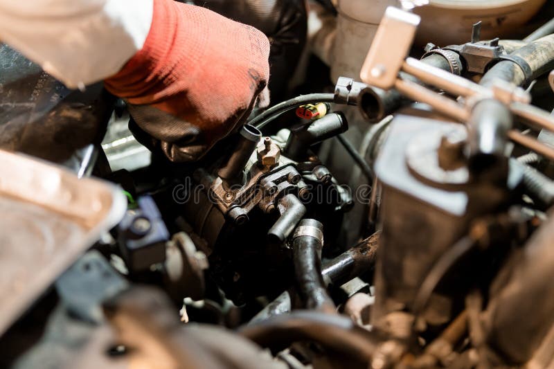 Car Mechanic Working on Fuel Injector in Engine Compartment Stock Image ...