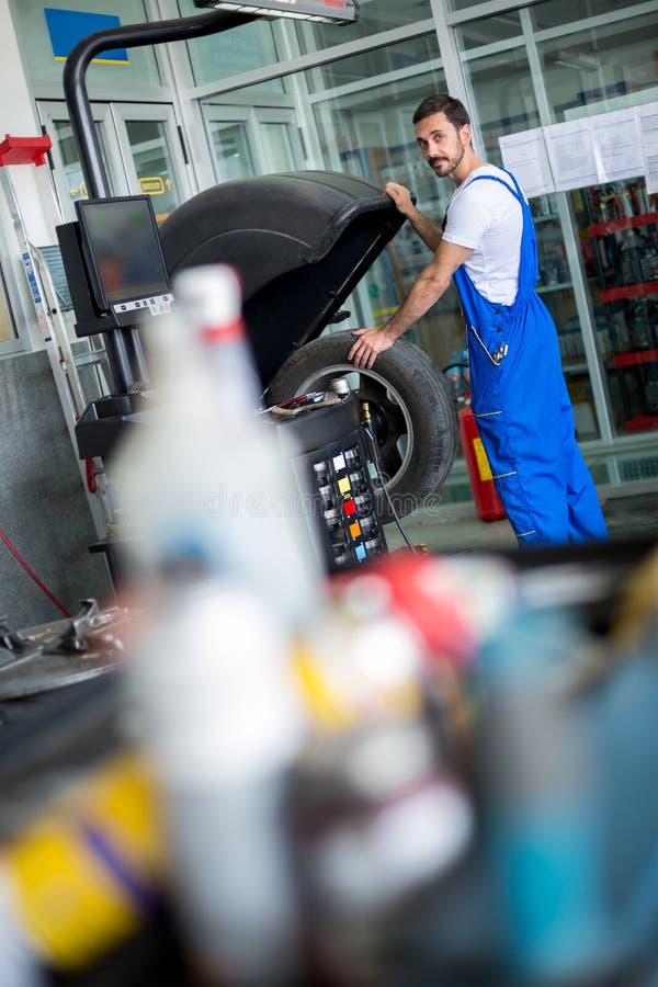 Car Mechanic Working with Machine Balancer Stock Image - Image of ...