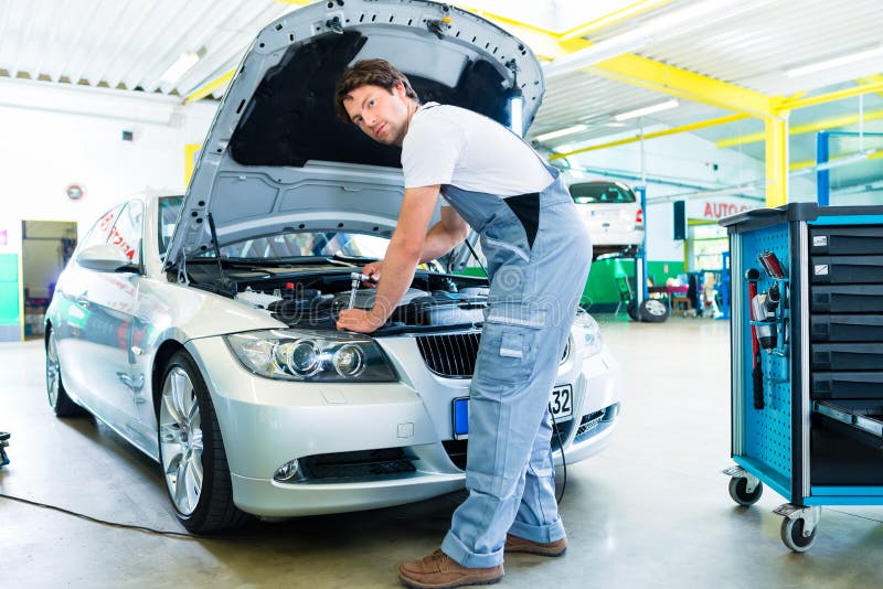 Mechanic Team Working in Car Workshop Stock Image - Image of team ...