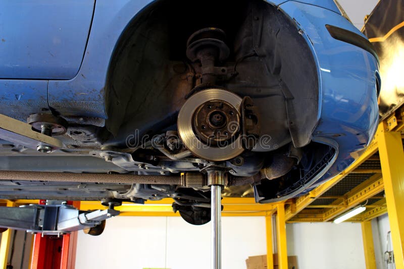 Car in the Workshop on a Mechanical Bridge Stock Photo - Image of motor ...
