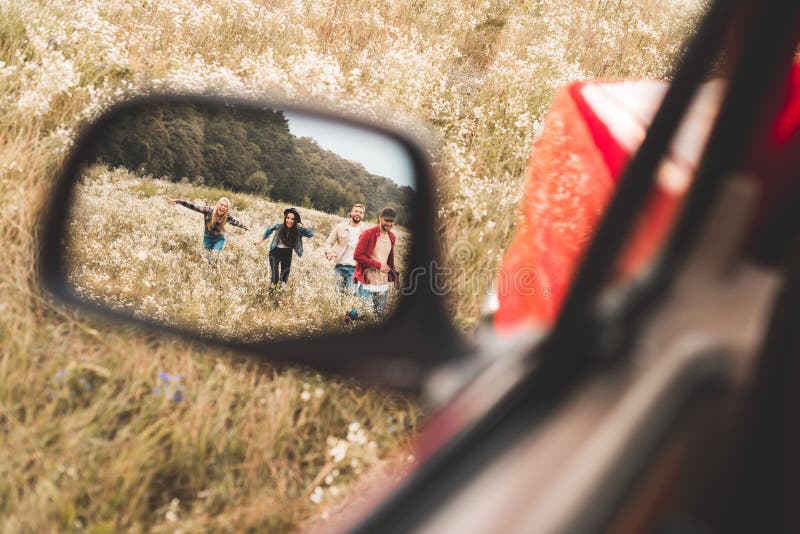 Car Mirror Reflection of Group of Young People Running Stock Photo ...