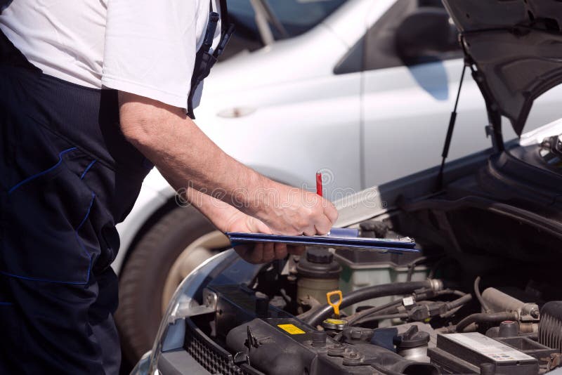 Car or Motor Mechanic Checking a Car Engine and Writing on the C Stock ...