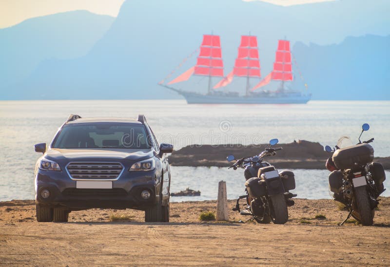 Car and Motorcycles on the Shore of the Lagoon in the Mountains and a ...
