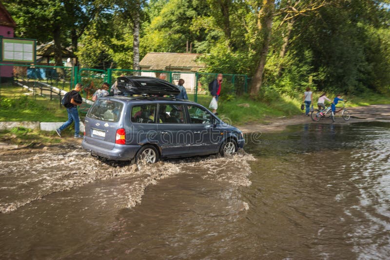 Car Moving Deep in Puddle after Rain on Baltic Spit Editorial Image ...