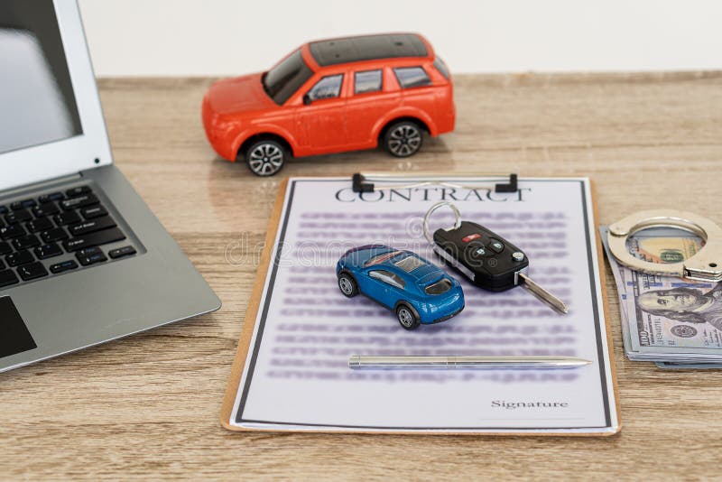 Car and Notebook Contract Documents with Keys with Money on the Table ...