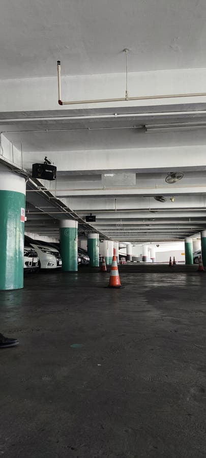 A Car Park in a Building with Many Parked Cars Stock Photo - Image of ...