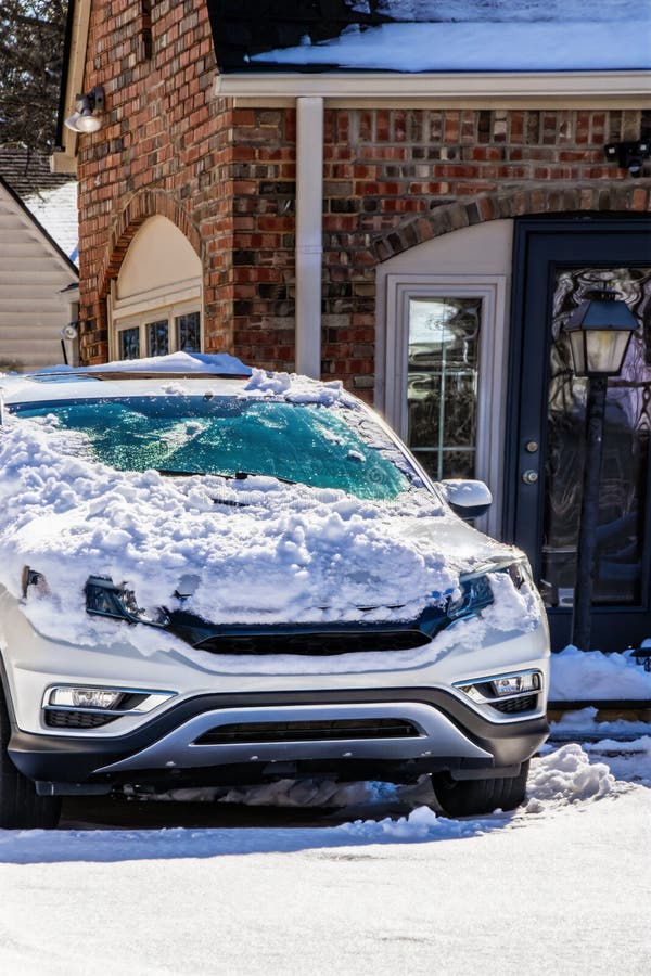 Car Parked in Driveway of Brick House with Windshield Partly Covered ...
