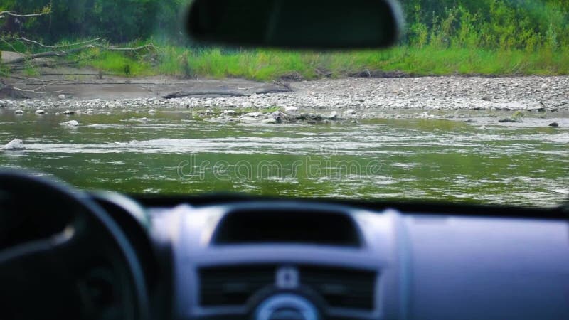 The Car is Parked on the River Bank. the River is Visible through the ...