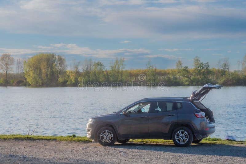 Car is Parked in a Scenic Location by a Lake, with the Trunk Open ...