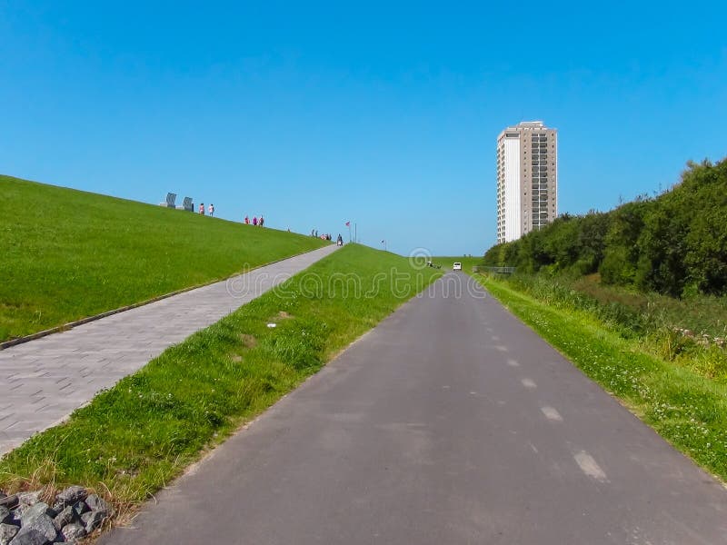 A Car Path and a Pedestrian Path Leading Up a Green Slope Stock Photo ...