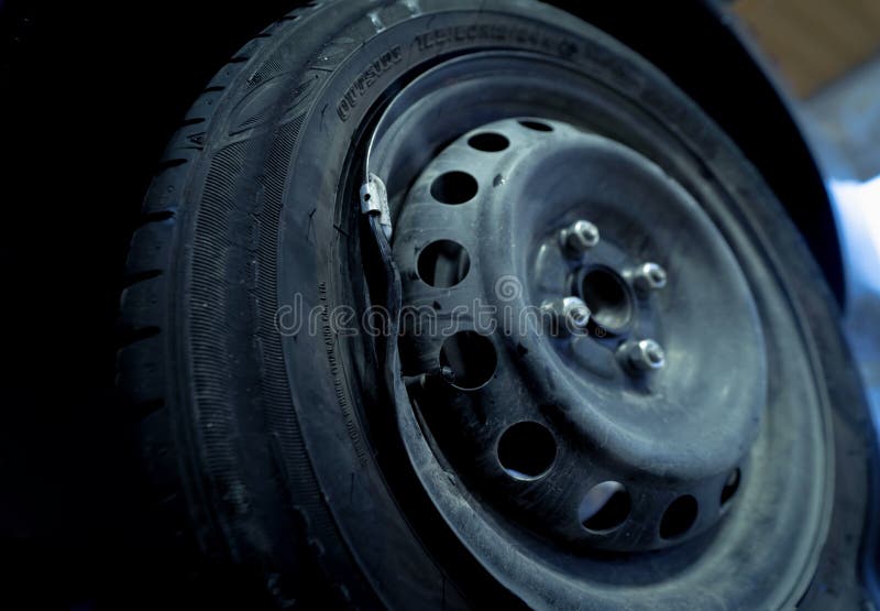 Car with a Punctured and Broken Wheel in a Car Repair Shop Stock Image ...