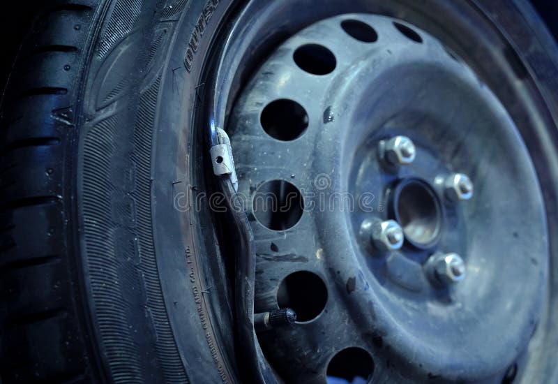 Car with a Punctured and Broken Wheel in a Car Repair Shop Stock Photo ...