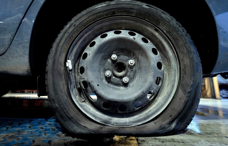 Car with a Punctured and Broken Wheel in a Car Repair Shop Editorial Photo - Image of worker ...