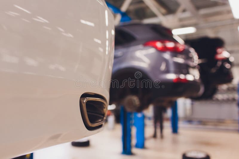 A Car Raised On A Lift For Repair And Under It A Detached Transmission ...