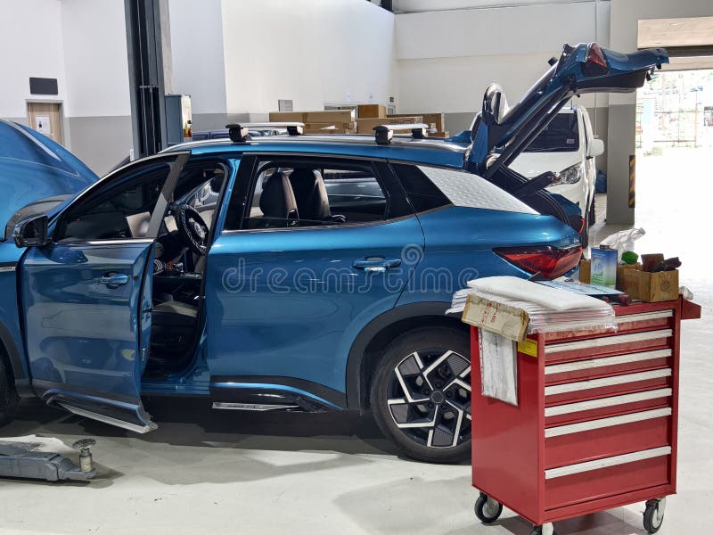 A Car is Raised Up Using a Lift Inside a Service for Maintenance Stock ...