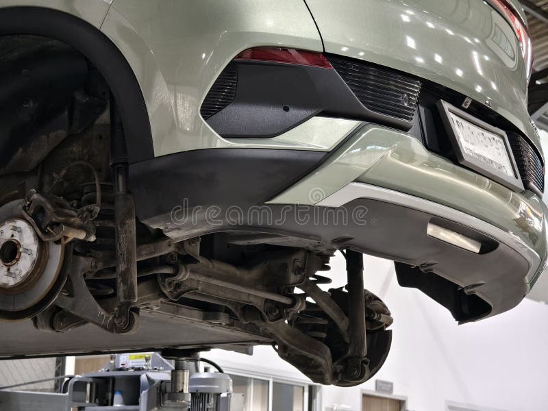 A Car is Raised Up Using a Lift Inside a Service for Maintenance Stock ...