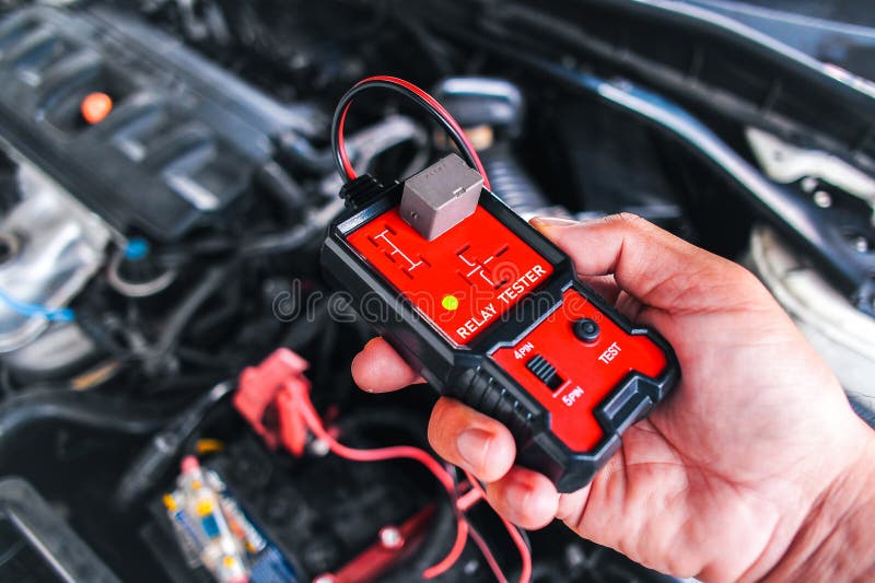 Car Relay Testing with a Relay Tester , Relay Tester in a Mechanic Hand ...