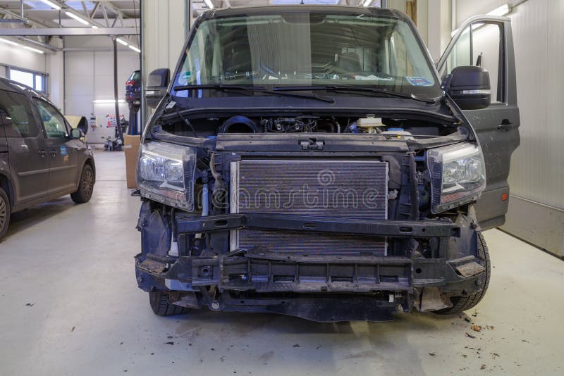 In a Car Repair Shop There is a Van Whose Front Was Severely Damaged by ...