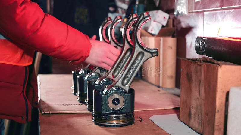 A Car Repairman Puts Car Engine Pistons on the Table. Stock Footage ...