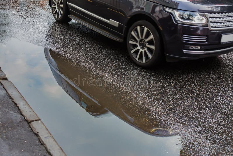 Car Rides Past a Puddle on the Road Stock Photo - Image of weather ...