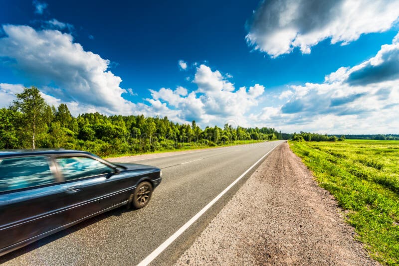 Car rides on a rural road stock photo. Image of marking - 240635166