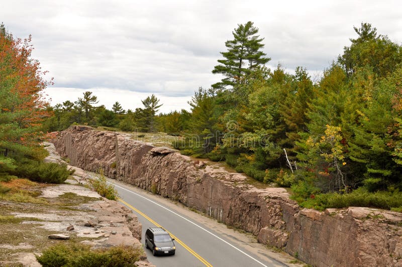 Car on a Road through a Rock Cut Stock Photo - Image of road, autumn ...