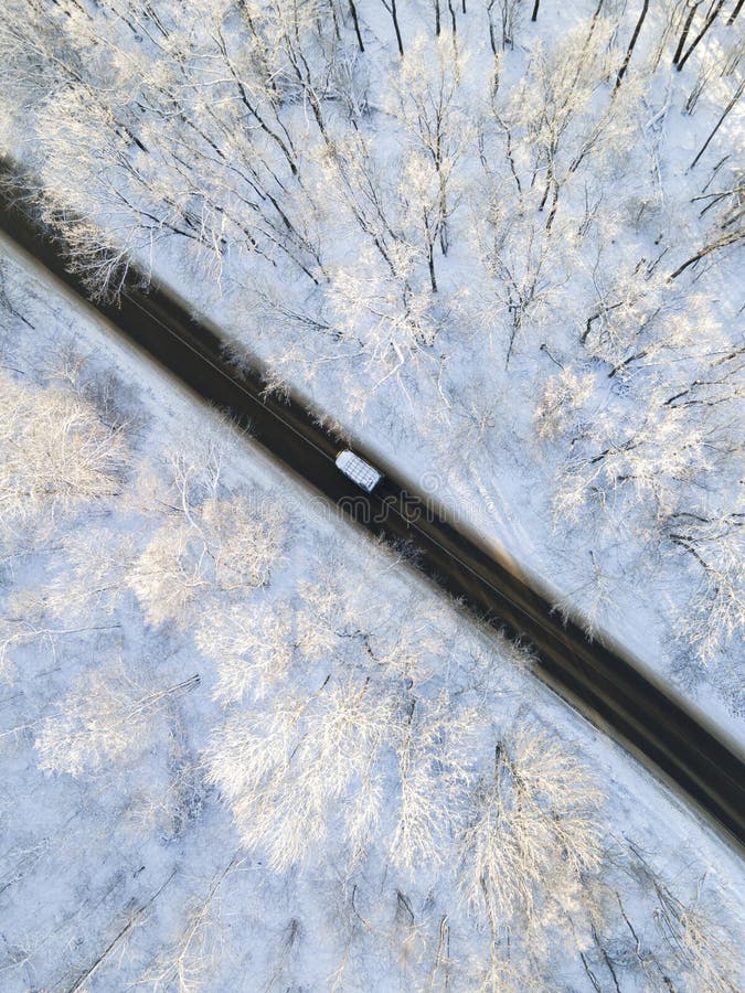 Car on the Road Surrounded by Winter Forest. Aerial Top View Stock ...