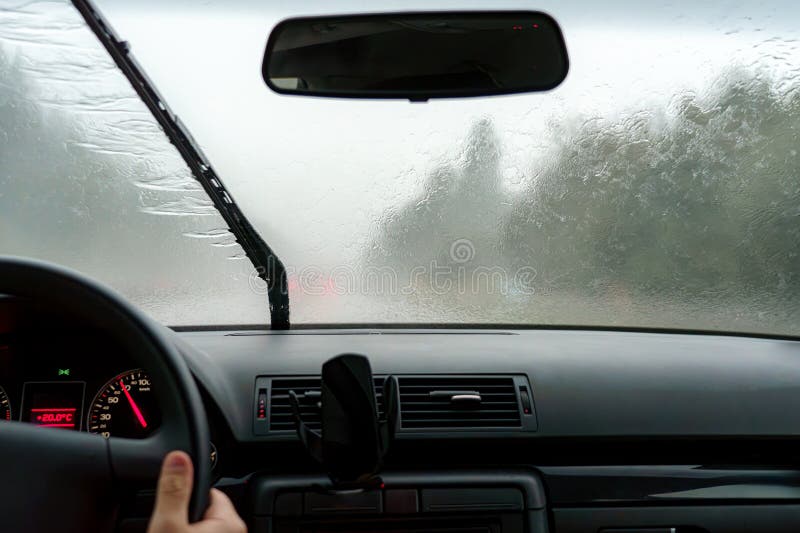 The Car S Windshield Wipers Work during Rain while Driving on the Road ...
