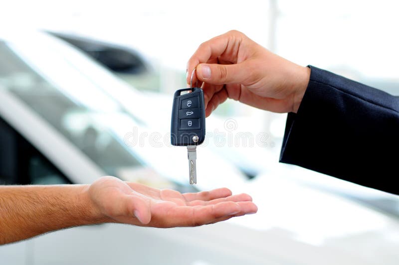 Car Salesman Handing Over Car Keys in Dealership Stock Image - Image of ...