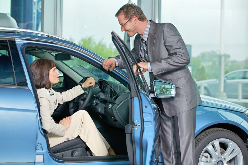 Car Salesperson Explaining Car Features To Customer Stock Image - Image ...