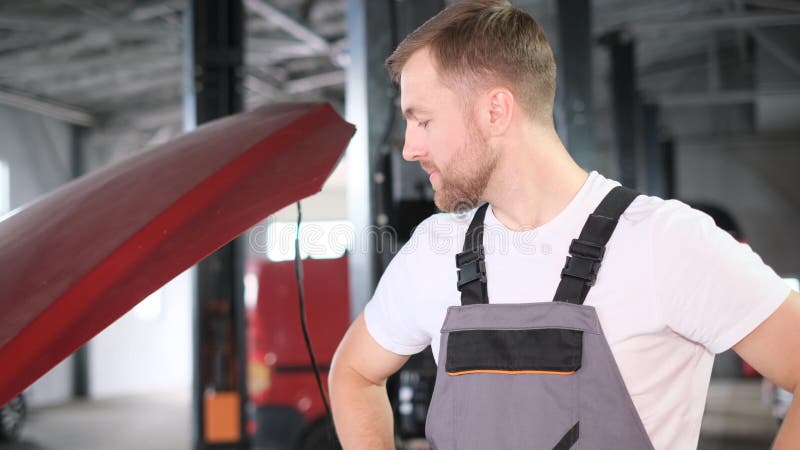 Handsome Young Car Mechanic in Uniform Looking at Camera and Smiling ...