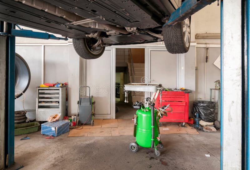 Luxury Cars Being Repaired in a Modern Garage. View through Red Stock ...