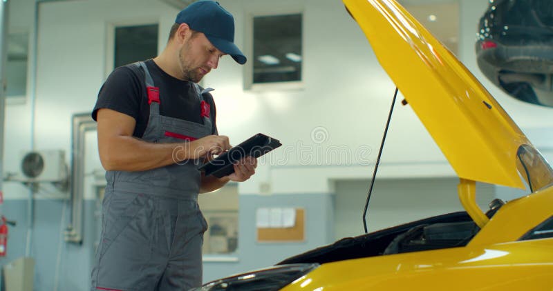 Car Service Manager Uses a Tablet Computer with an Augmented Reality ...