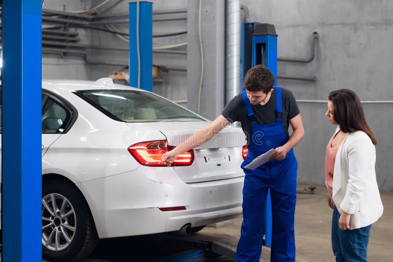 A Car Service Worker Asks a Client about Repair Stock Photo - Image of ...