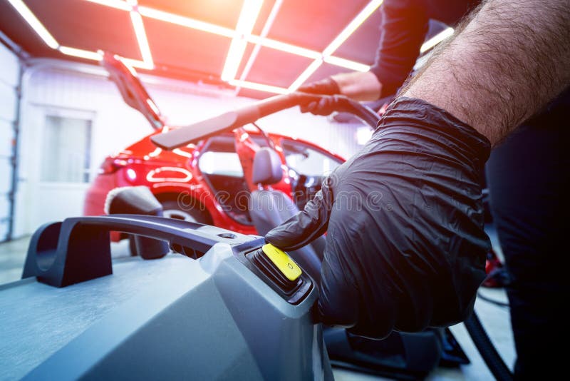 Car Service Worker Cleaning Car Seat with Vacuum Cleaner. Stock Image ...