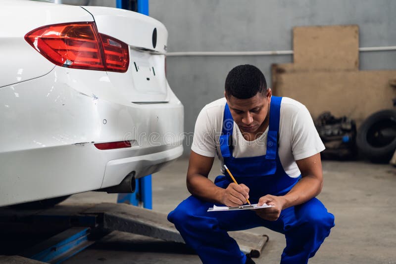 A Car Service Worker with a Clipboard Inspects Car Stock Image - Image ...