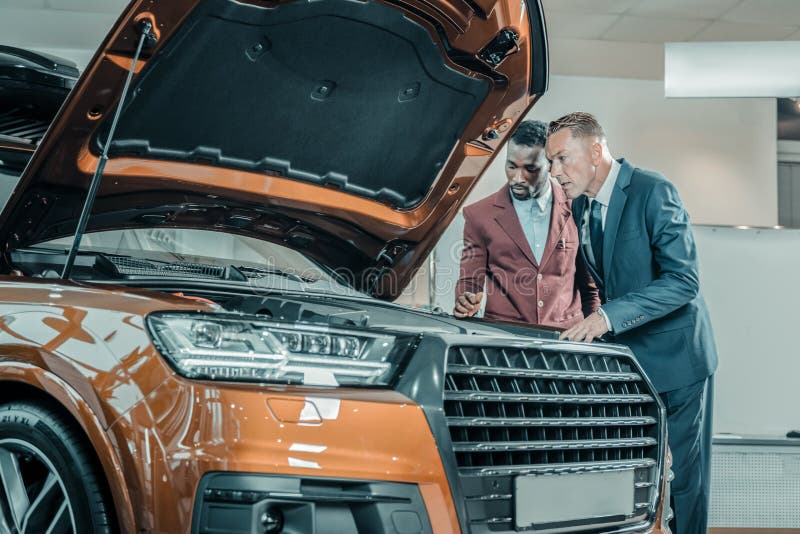 Car Showroom Visitor Exploring the Construction of Automobile. Stock ...