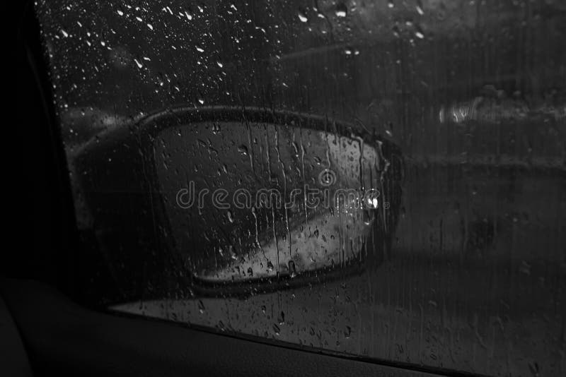 Car Side Mirror with Headlight Reflection in Rain Stock Image - Image ...