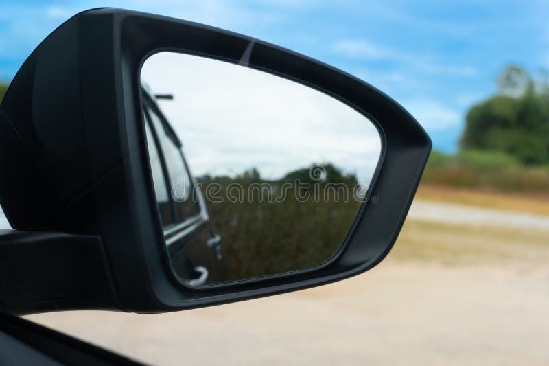 Car Side Mirror Reflects a Road, Greenery and a Cloudy Sky. Stock Photo ...