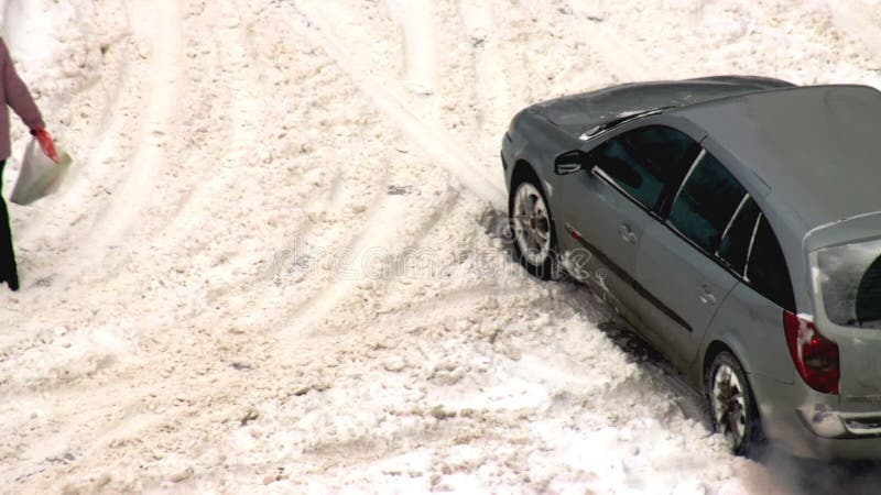 The Car Slips in the Snow Under Which There is Ice on the Road in ...