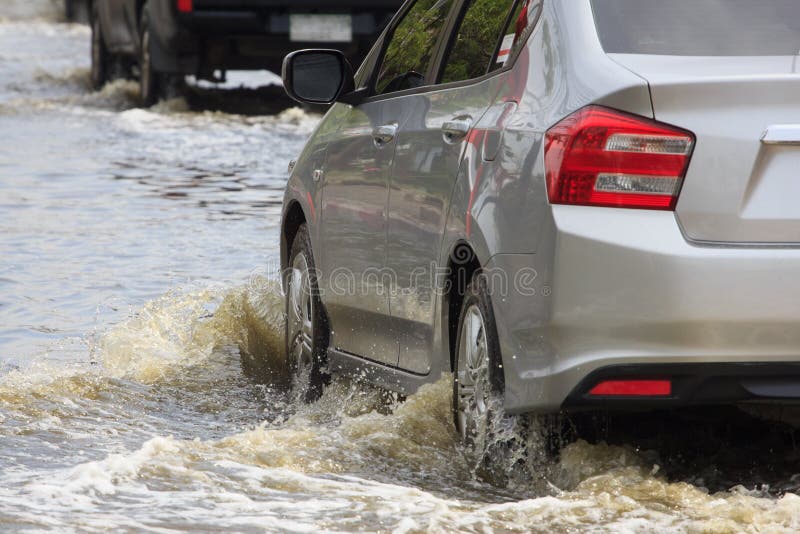 Car Splashes through a Large Puddle on a Flooded Stock Image - Image of ...