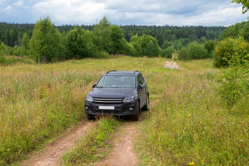 A Car Stands in a Rut on a Field Overgrown with Grass Stock Image ...