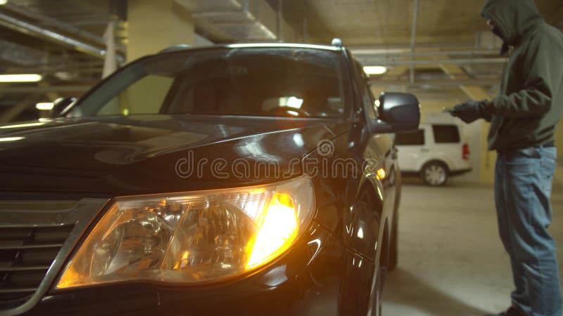 Car Thief Hacks a Car Using a Tablet and Sits in it Stock Image - Image ...