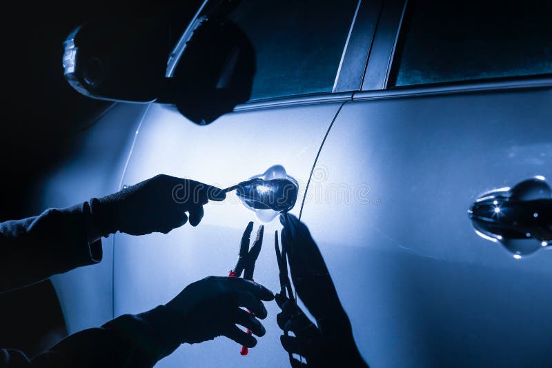 Car Thief Using a Tool To Break into a Car Stock Photo - Image of ...