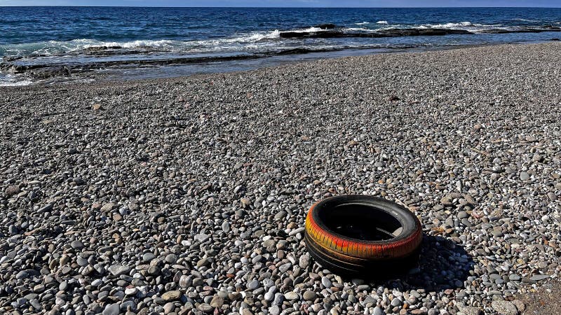 A Car Tire Dumped on the Beach Stock Image - Image of beach, damage ...
