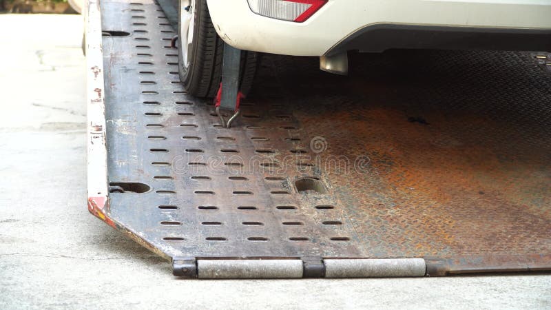 Car Tire Secured with Belt for Safety on Flatbed Tow Truck,Securing the ... Car Tire Secured with Belt for Safety on Flatbed Tow Truck,Securing the ...